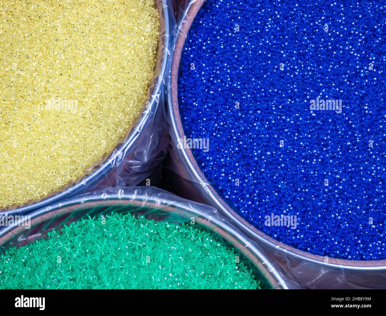 bins or barrels of Colorful plastic beads. Microplastics. Industrial ...