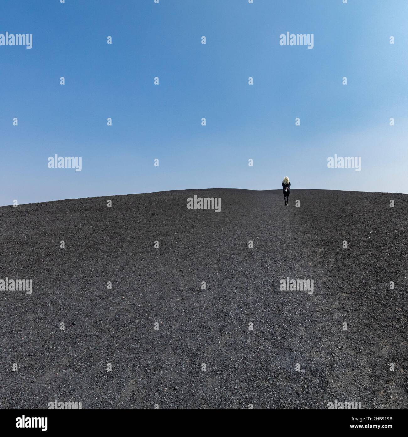 Woman hiking in cinder cone at Craters of the Moon National Monument ...