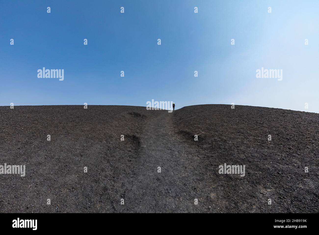 Woman hiking in cinder cone at Craters of the Moon National Monument ...