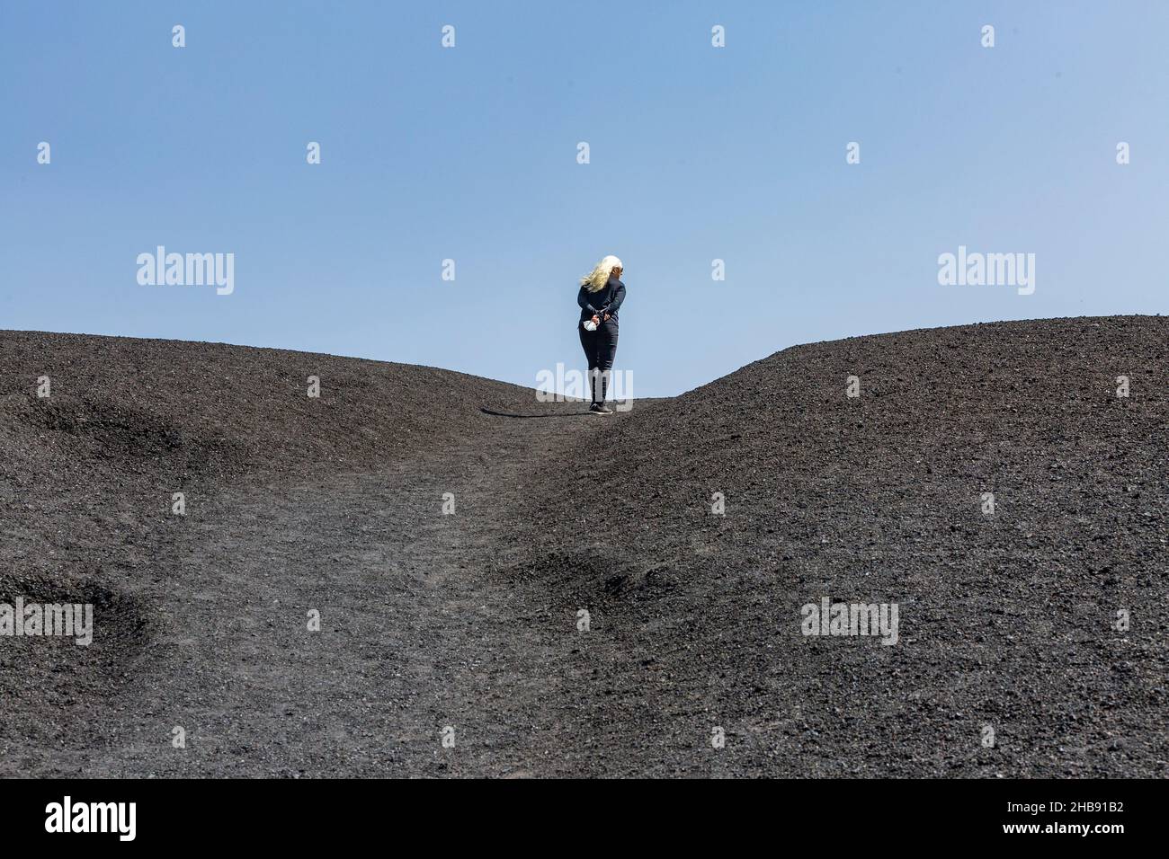 Woman hiking in cinder cone at Craters of the Moon National Monument ...
