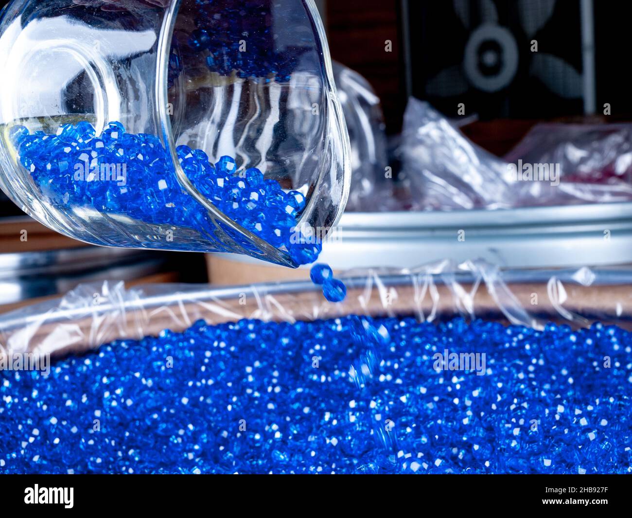 Pouring of Colorful plastic beads. Microplastics. Industrial plastic ...