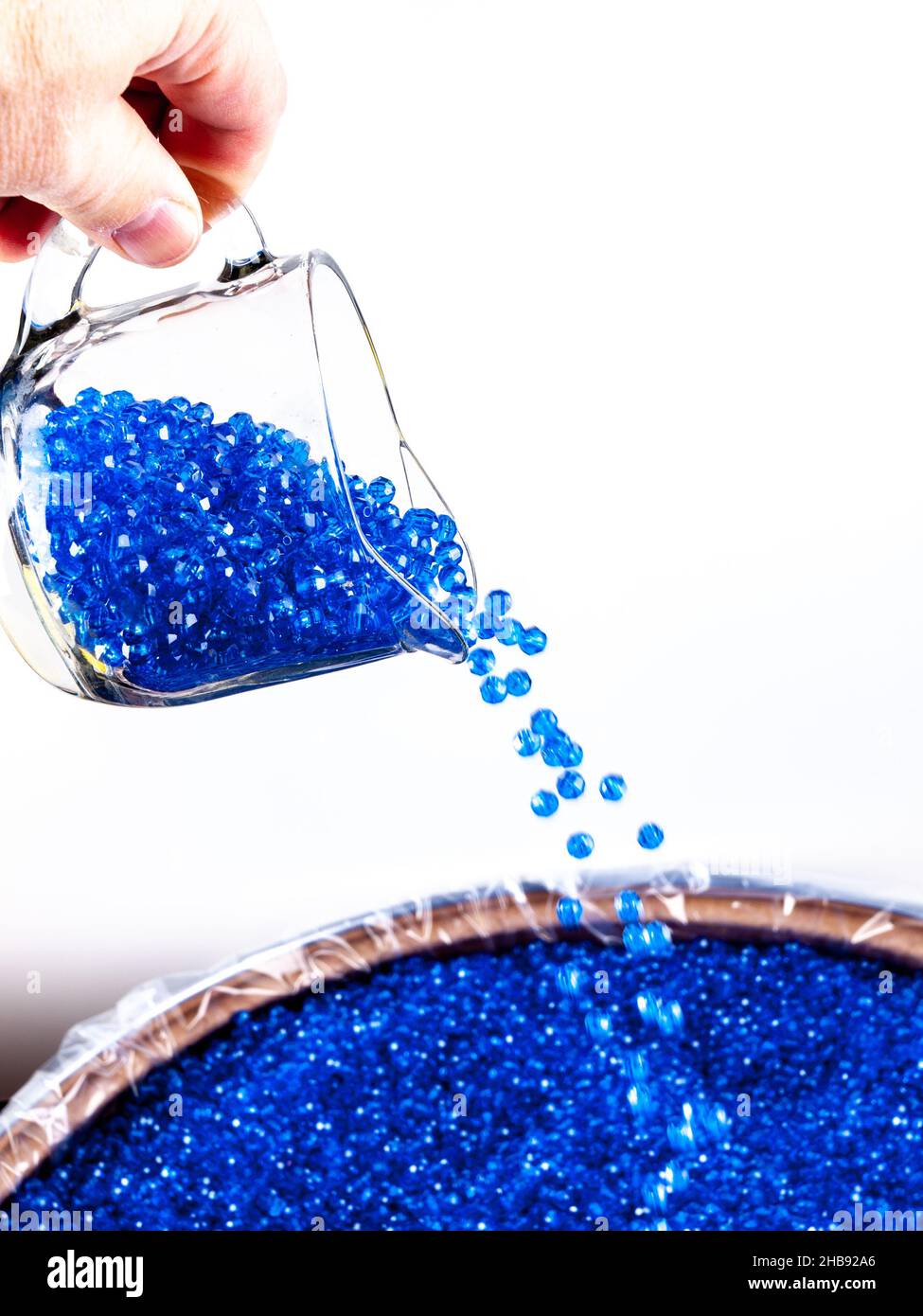 Pouring of Colorful plastic beads. Microplastics. Industrial plastic ...