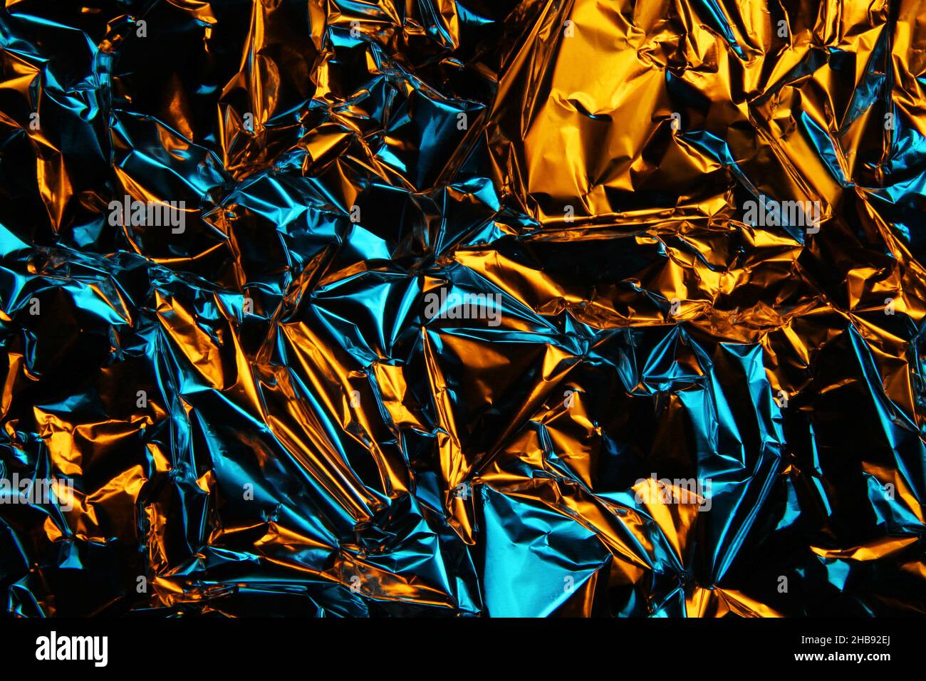 Foil background. Crumpled foil. Abstract background. Wallpaper. Yellow ...