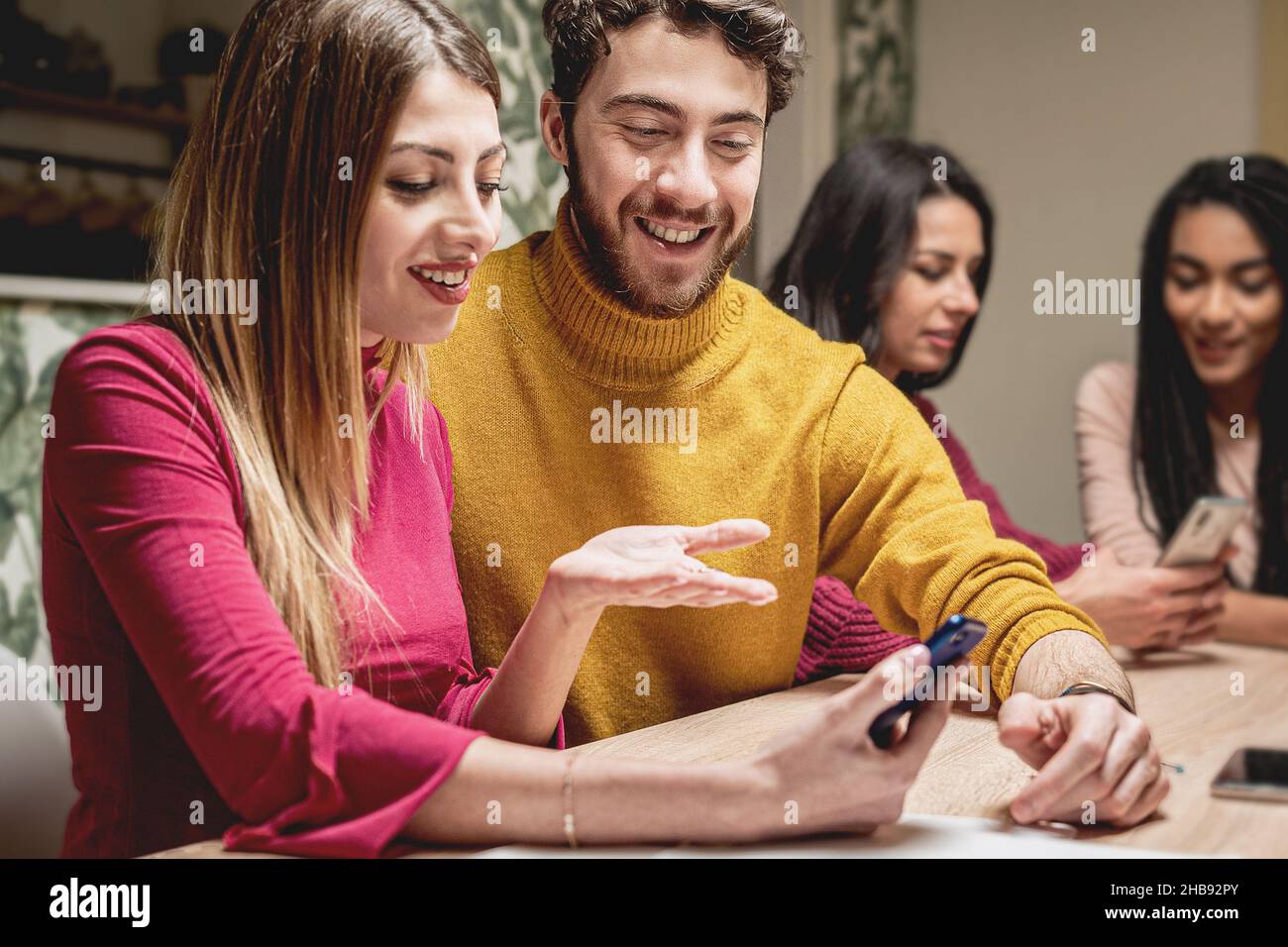 Friends reunion party indoor with group of young people using ...