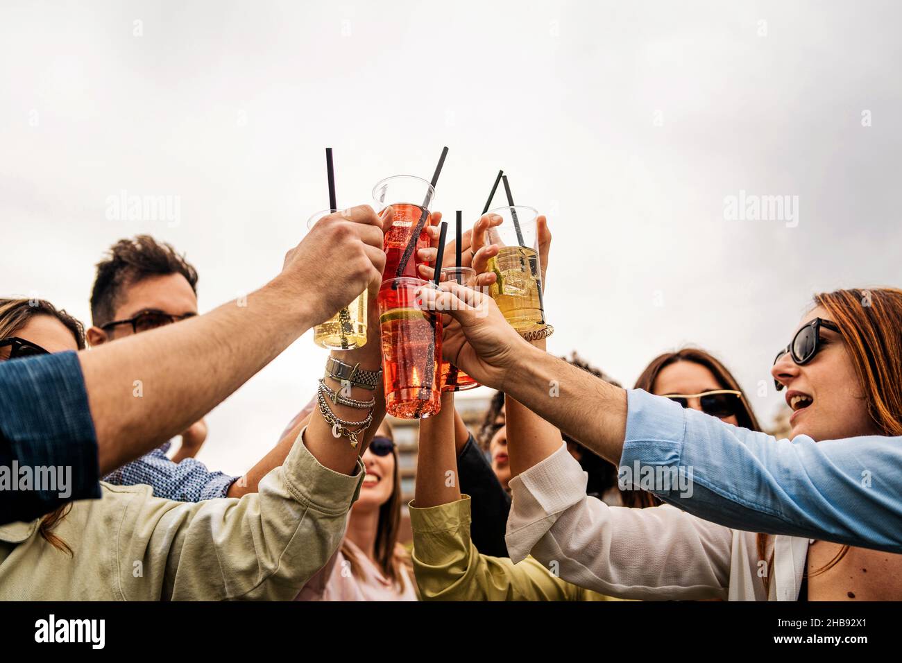 Group of friends joining cocktail glasses outdoors - Young people ...