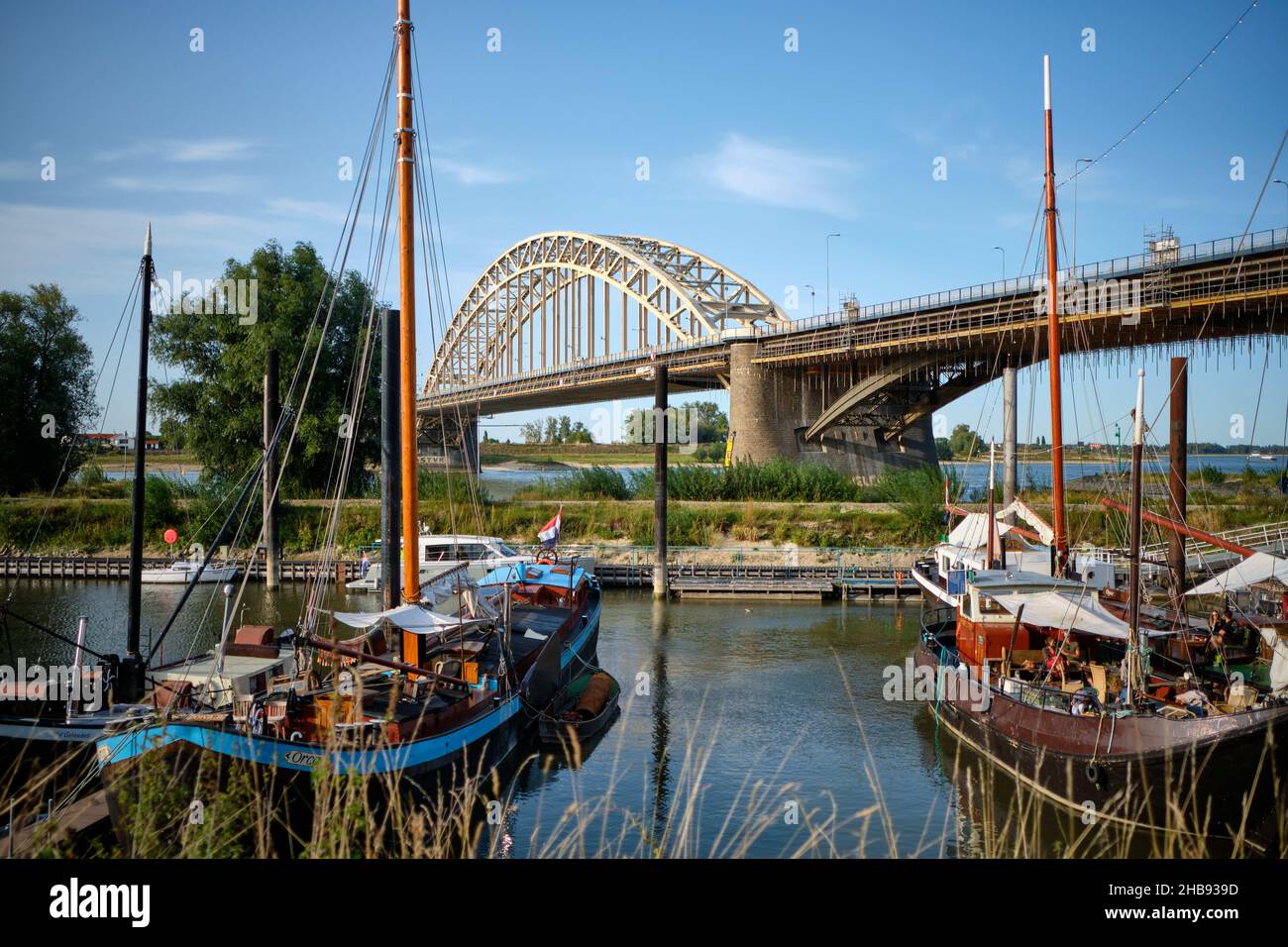 view of the harbor with beautiful ships and Waalbrug bridge in the ...