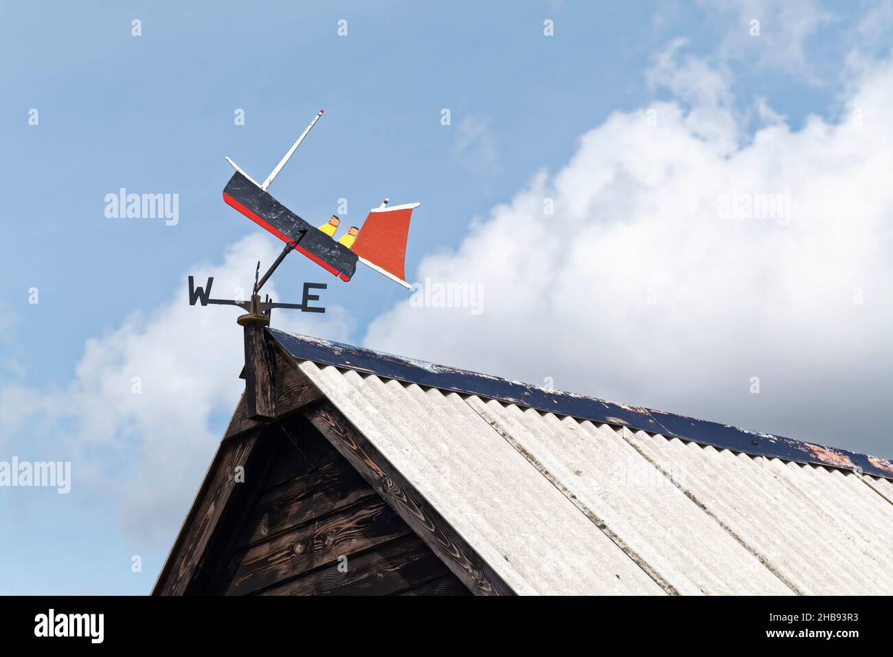 Weather vain of a fishing boat on the roof of a shed, With copy space ...