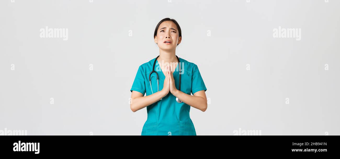 Covid-19, healthcare workers, pandemic concept. Overworked sad and ...