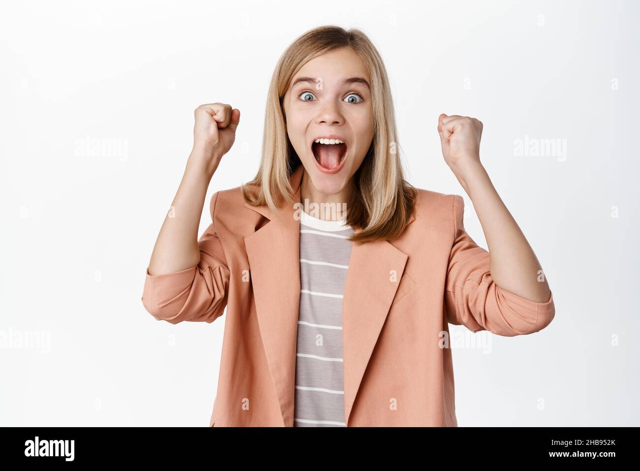 Portrait of cute girl winner, teen kid in blazer, celebrating victory ...