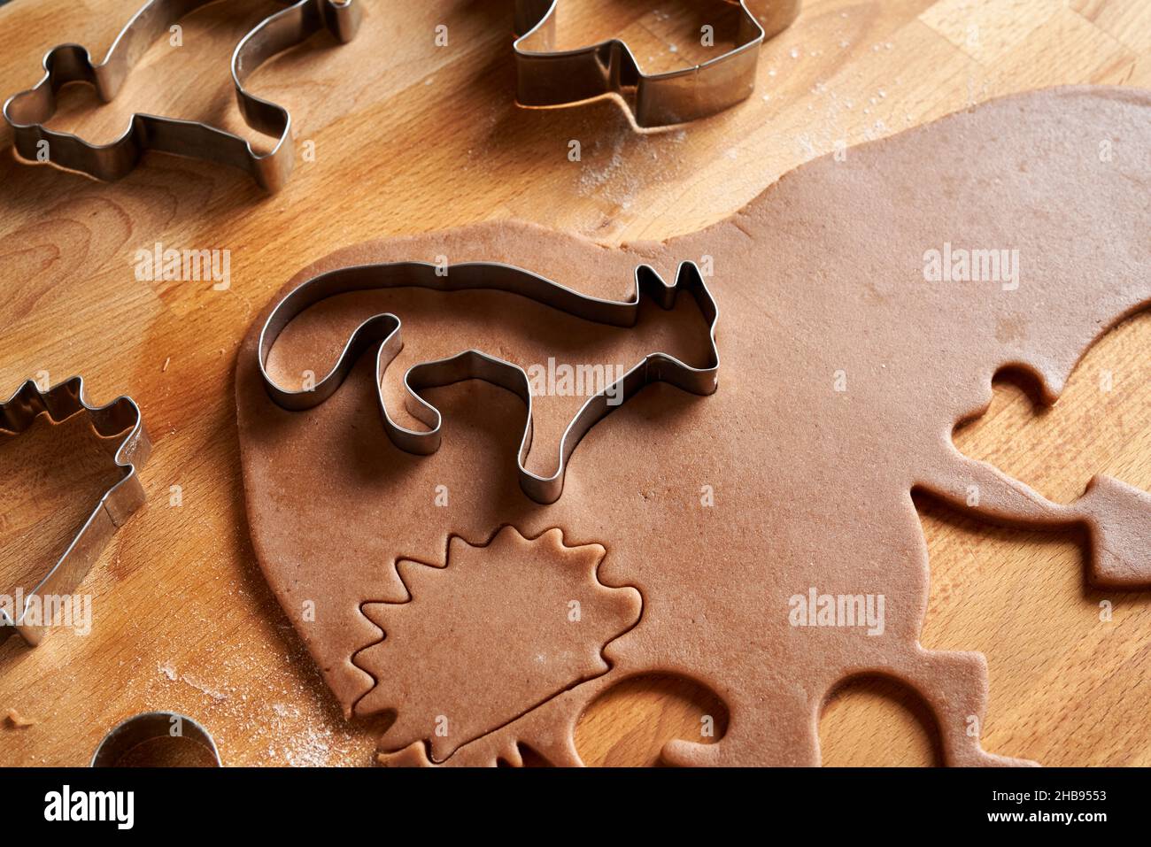 Cutting out a fox shape from pastry dough to prepare homemade ...