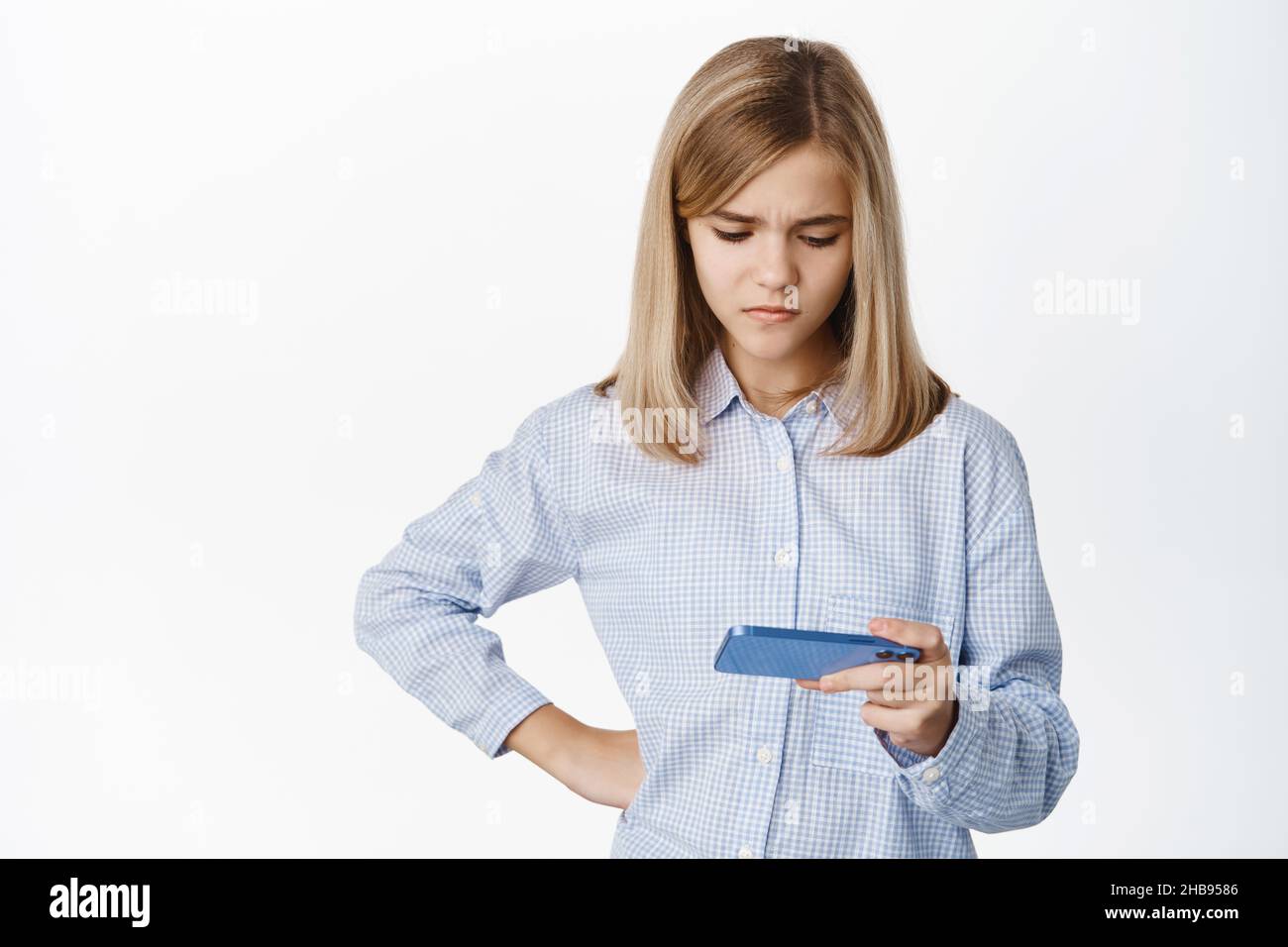 Image of small girl, schoolgirl e-learning on mobile phone, watching ...