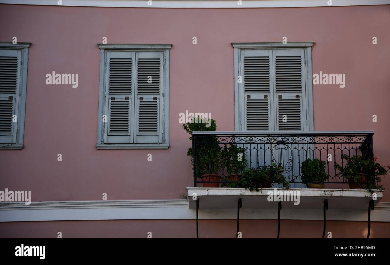 Old Neoclassical house facade with a salmon pink stucco wall, grey ...