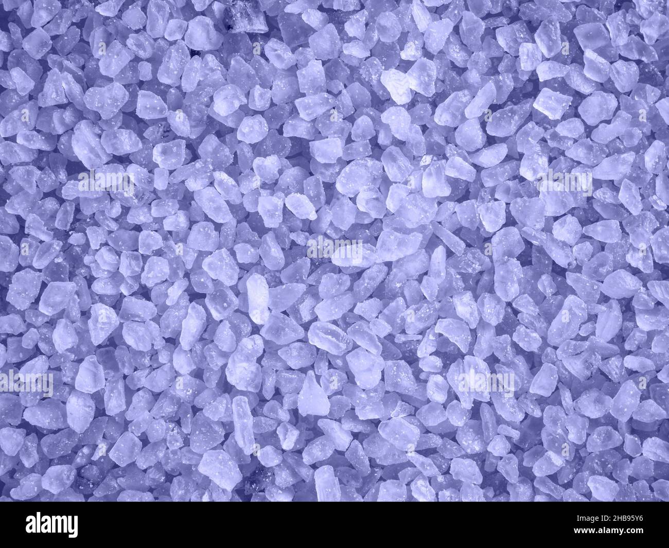 Purple colored salt crystals as a background. Aromatic lavander bath ...