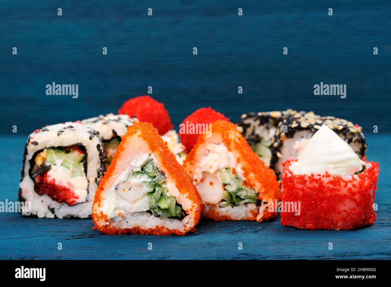 Set of various japanese fusion rolls on blue background copyspace Stock ...