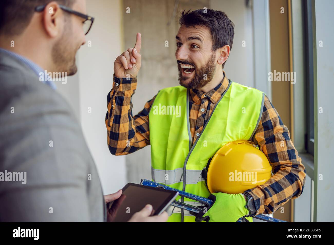 Smiling construction worker having and idea how to solve problem Stock ...
