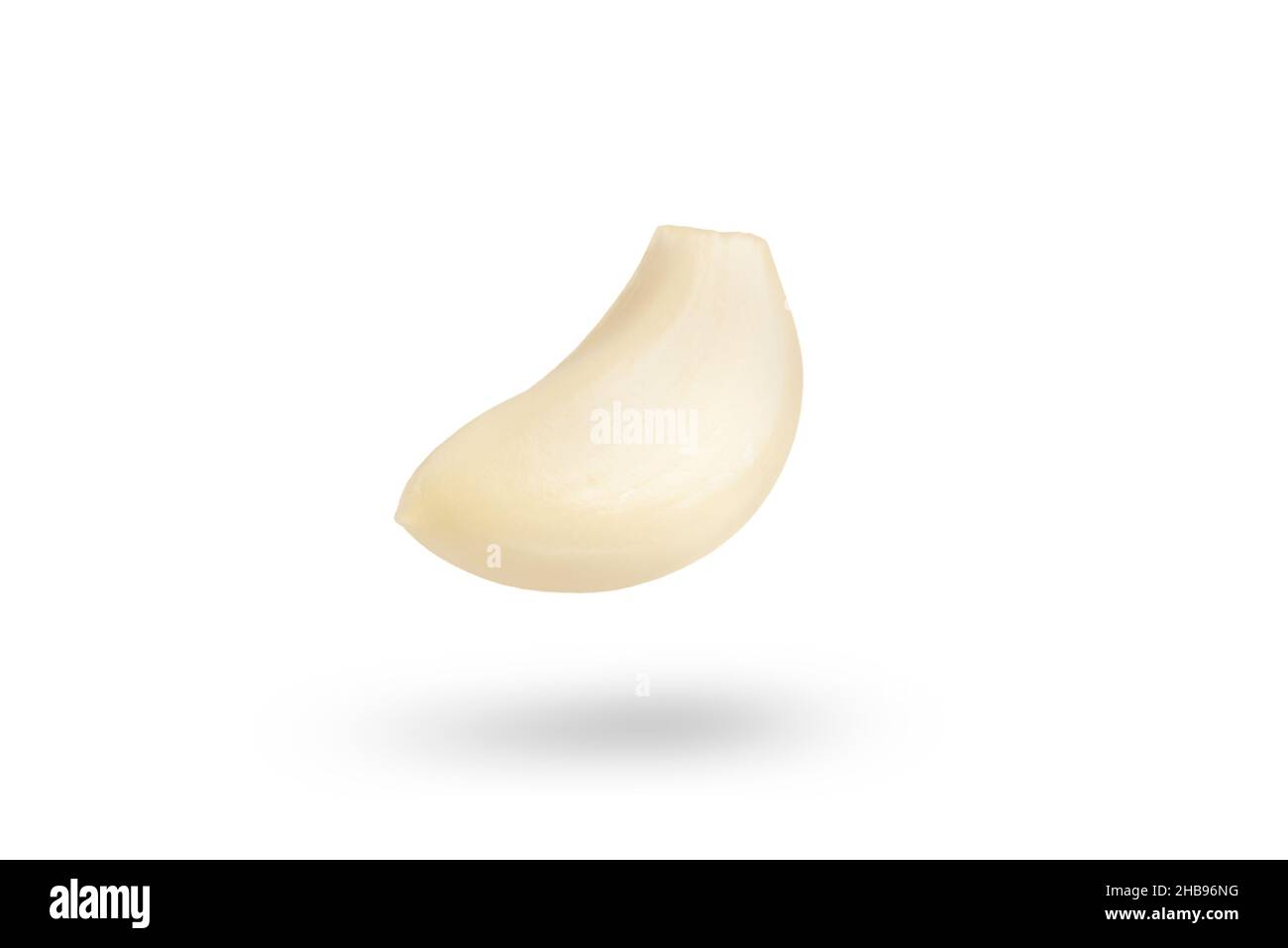 Garlic on a white background. Falling peeled clove of garlic falling on ...
