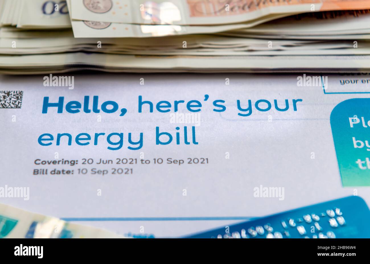 An energy bill with bank notes and payment card. Energy cost concept ...