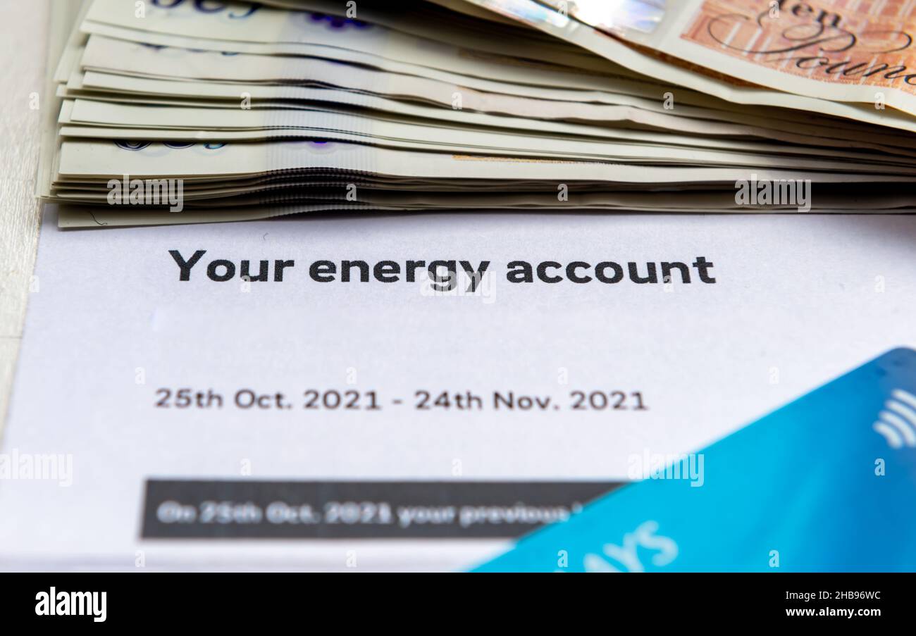 Close up of a bill demand payment for energy use with a stack of bank ...
