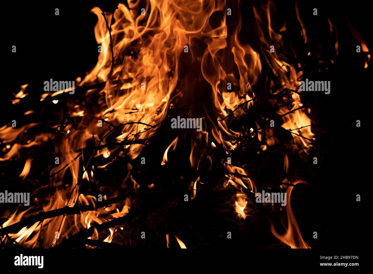A fire is burning at night. Fine branches on fire. Lighting the fire ...