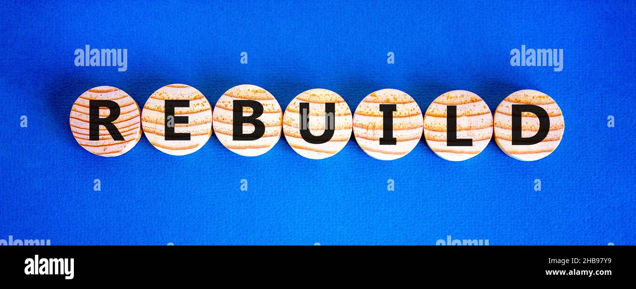 Rebuild and build symbol. The concept word Rebuild on wooden circles ...