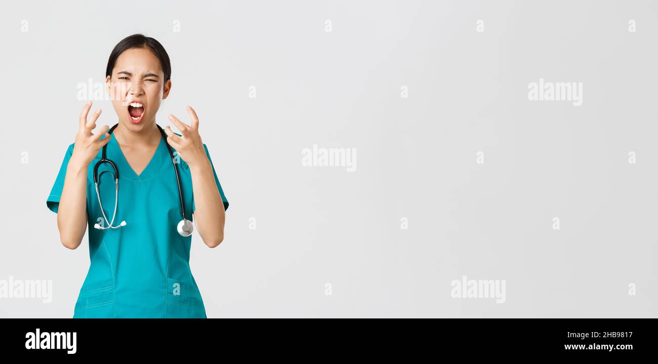 Covid-19, healthcare workers and preventing virus concept. Angry pissed ...