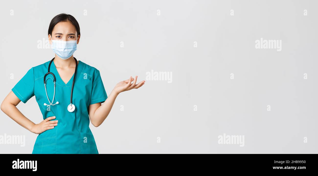 Covid-19, coronavirus disease, healthcare workers concept. Confused and ...