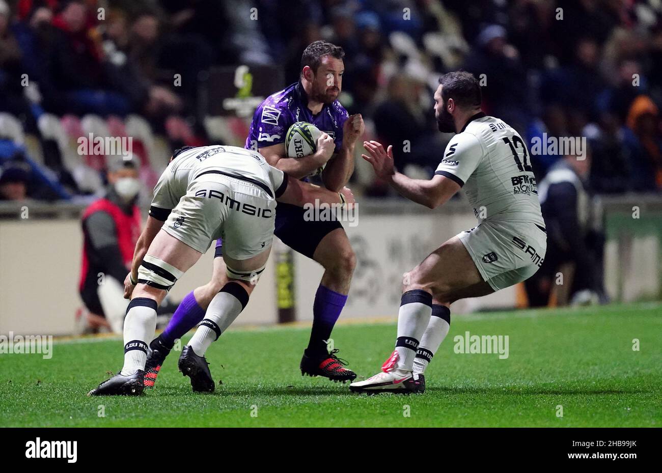 Dragons Adam Warren is tackled by Lyon’s Killian Geraci during the EPCR ...