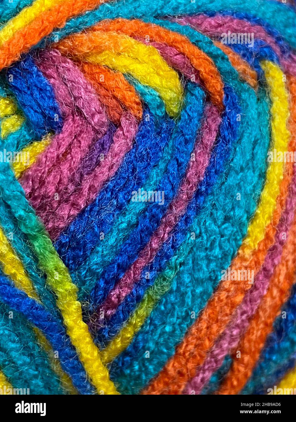 rainbow ball of wool yarn background Stock Photo - Alamy