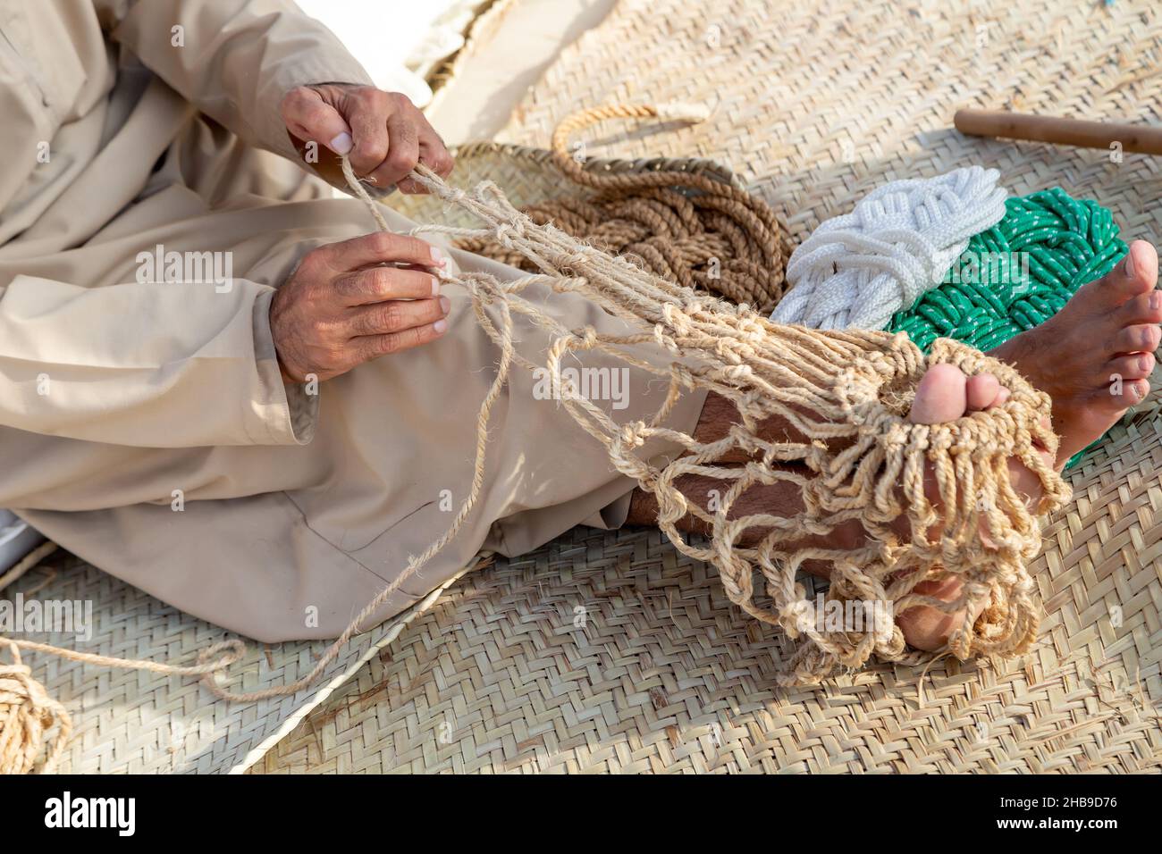 Old man is knitting traditional fishing net, hands in frame Stock Photo ...