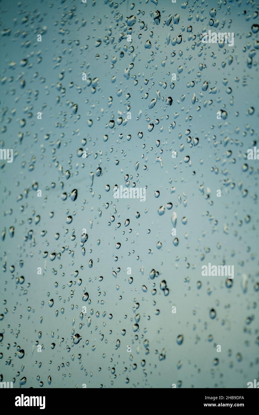 Vertical shot of a glass surface with rain drops Stock Photo - Alamy