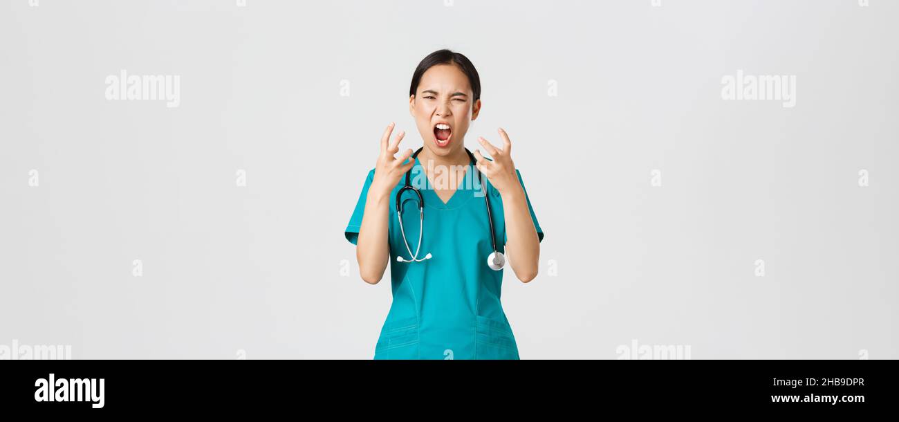 Covid-19, healthcare workers and preventing virus concept. Angry pissed ...