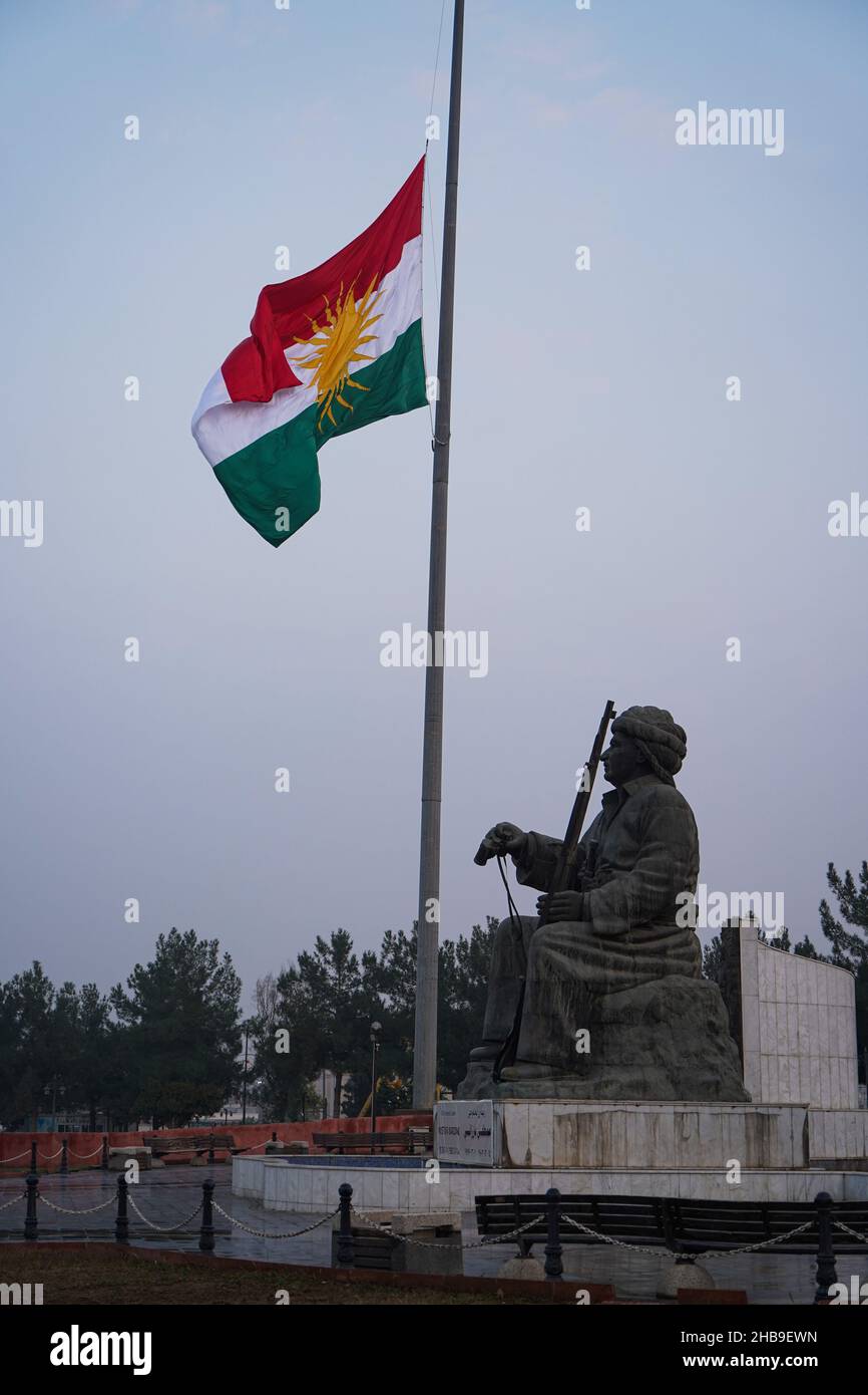 The Kurdistan flag seen waving over a statue of Kurdish leader Mulla ...