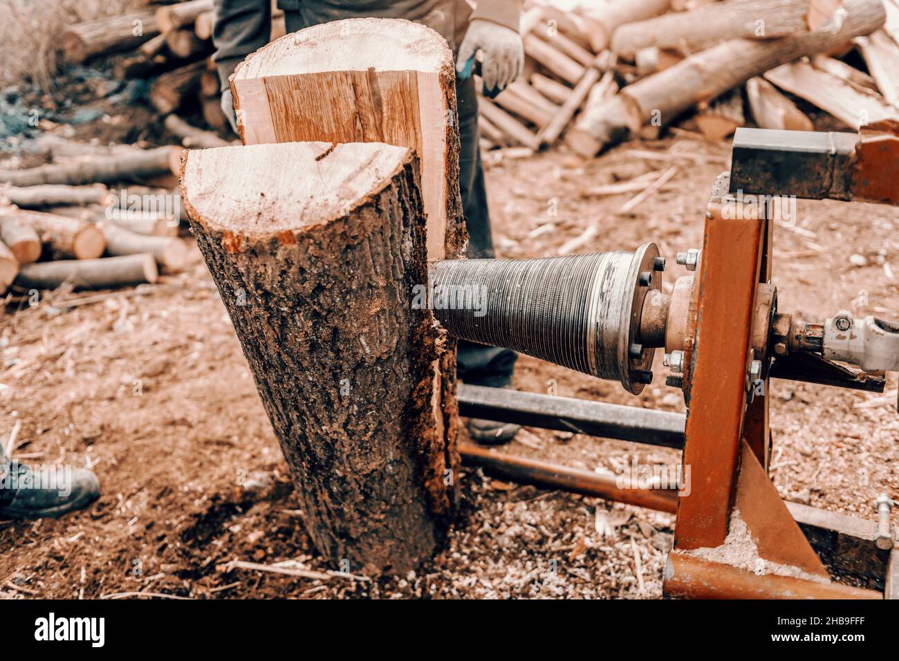 Workers cutting logs into peaces with cutting machine outdoors Stock ...