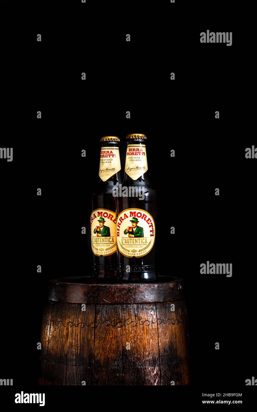 Bottle of Birra Moretti beer on wooden barrel with dark background ...