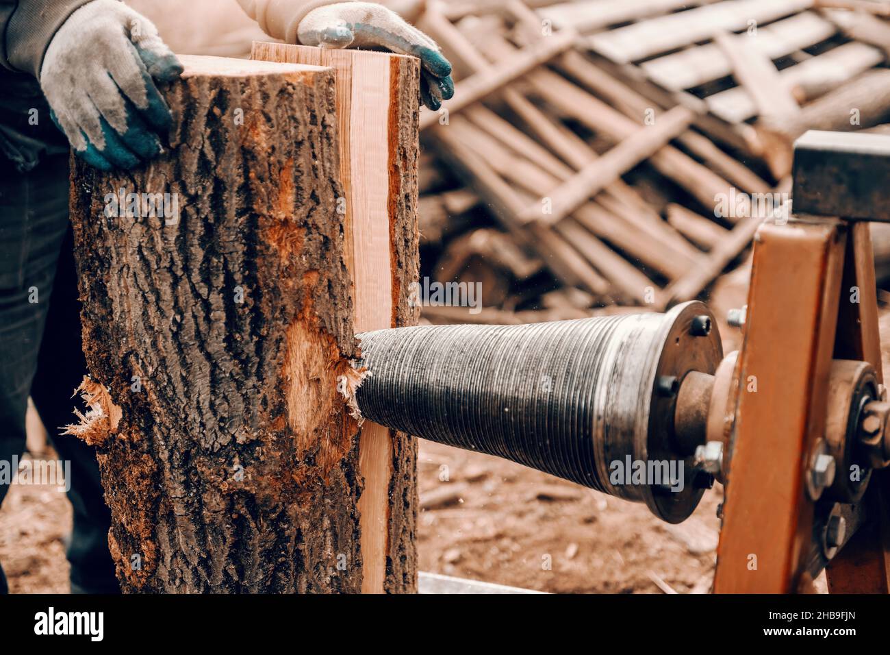 Workers cutting logs into peaces with cutting machine outdoors Stock ...