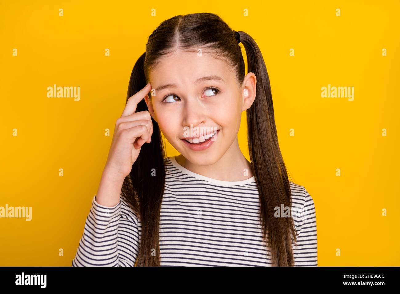 Photo of young school girl happy positive smile think finger touch head ...