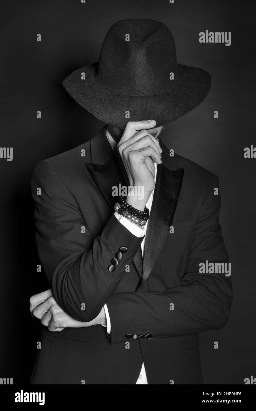 Secret adult mafia boss wearing a suit and covering his head with a ...