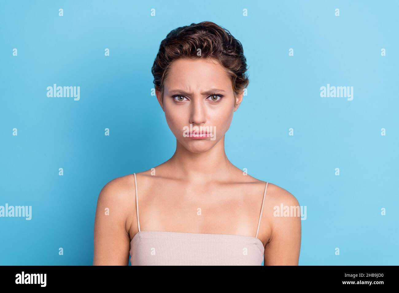 Photo of unhappy upset young woman dressed beige top knowing bad news ...