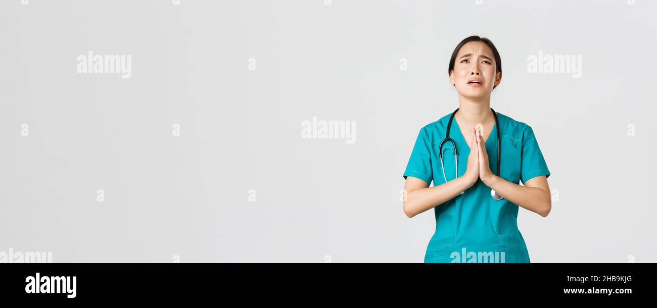 Covid-19, healthcare workers, pandemic concept. Overworked sad and ...