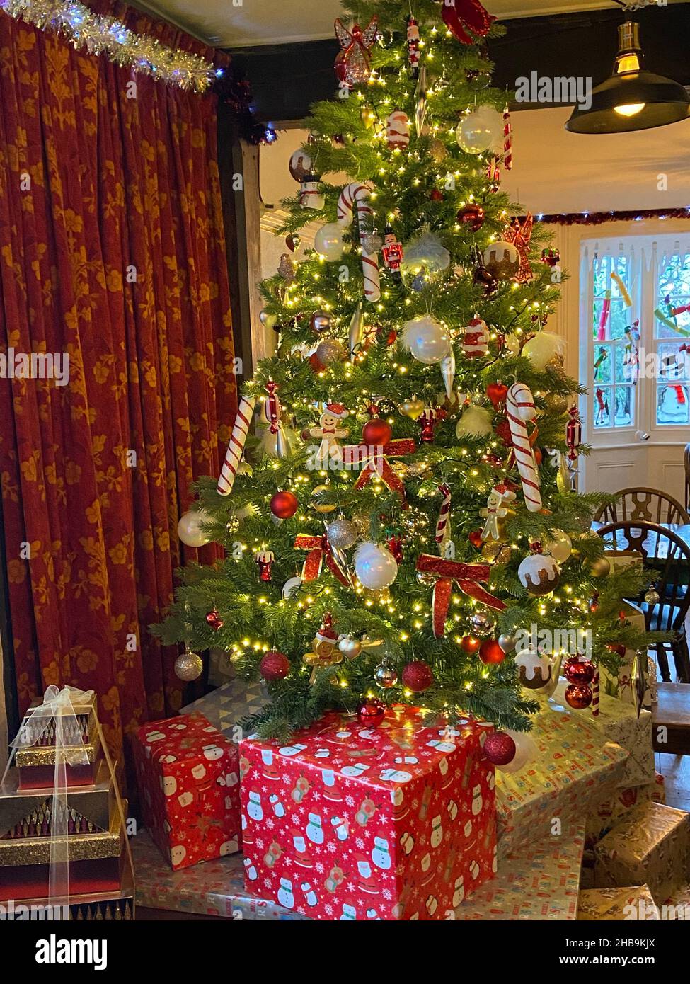 Christmas baubles and fairy lights on a Christmas tree siver gold red ...