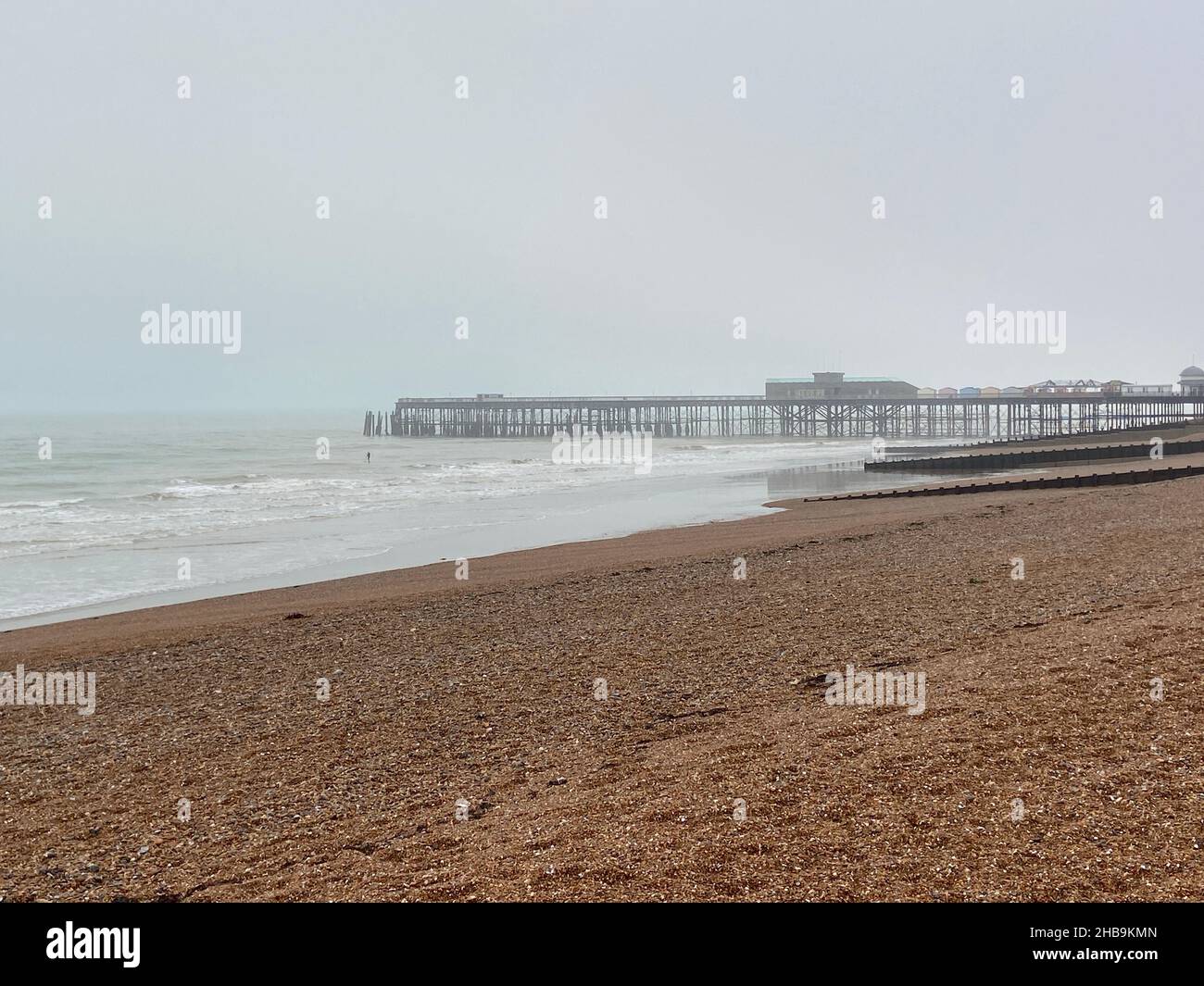 Hastings beach pier and seafront at sunset one man silhouette on ...