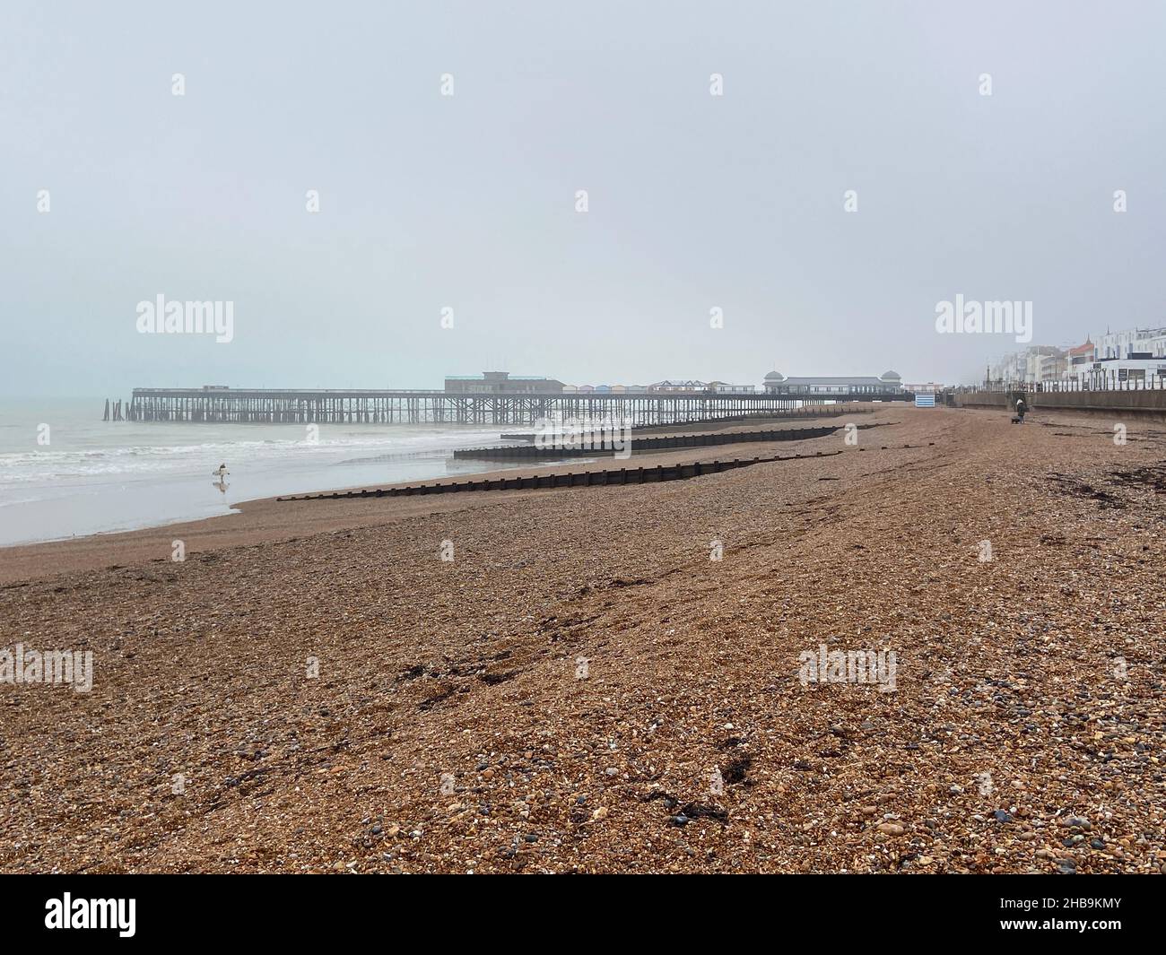 Hastings beach pier and seafront at sunset one man silhouette on ...