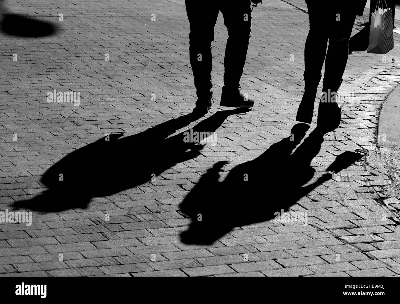 Shadows cast people walking hi-res stock photography and images - Alamy