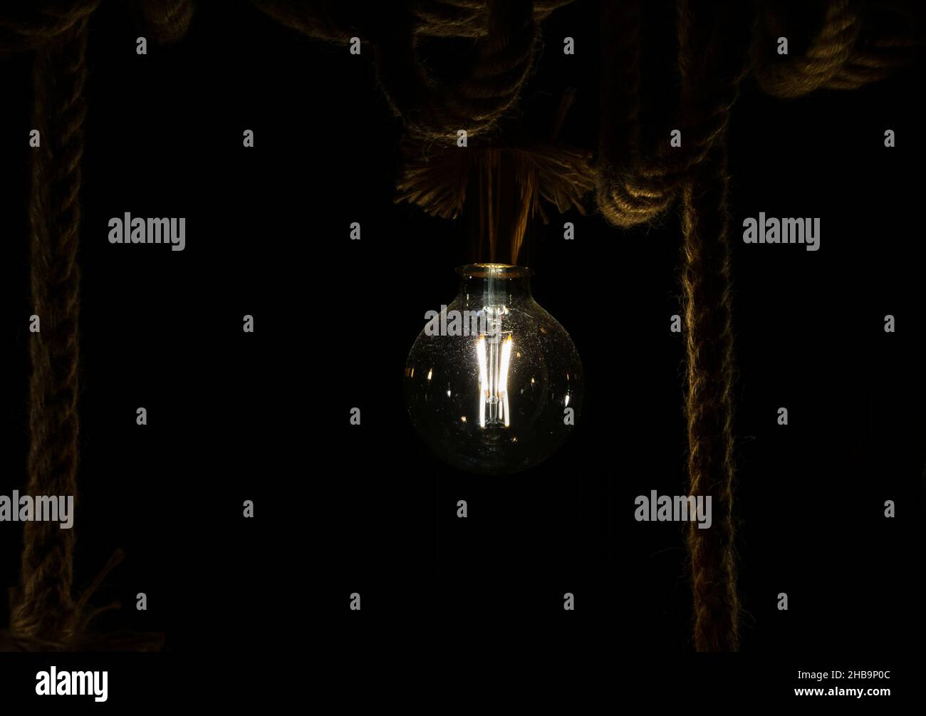 Dirty old light bulb on ropes Stock Photo - Alamy
