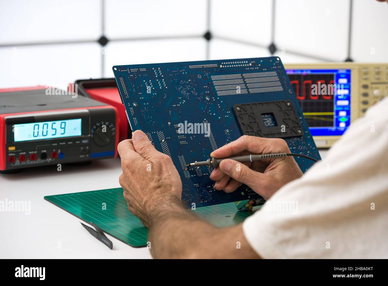 Technician repairing a motherboard in a customer service laboratory ...