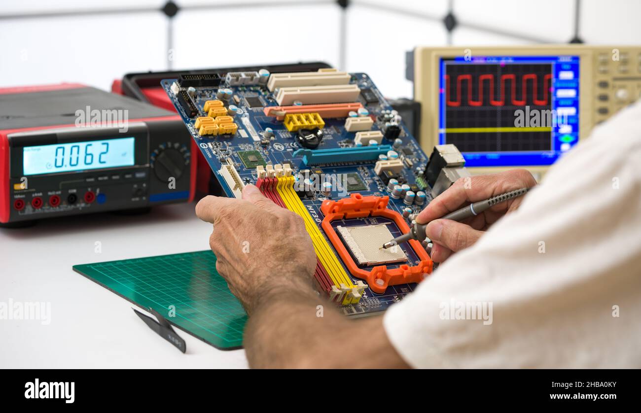 Computer motherboard repair in customer service laboratory workshop ...