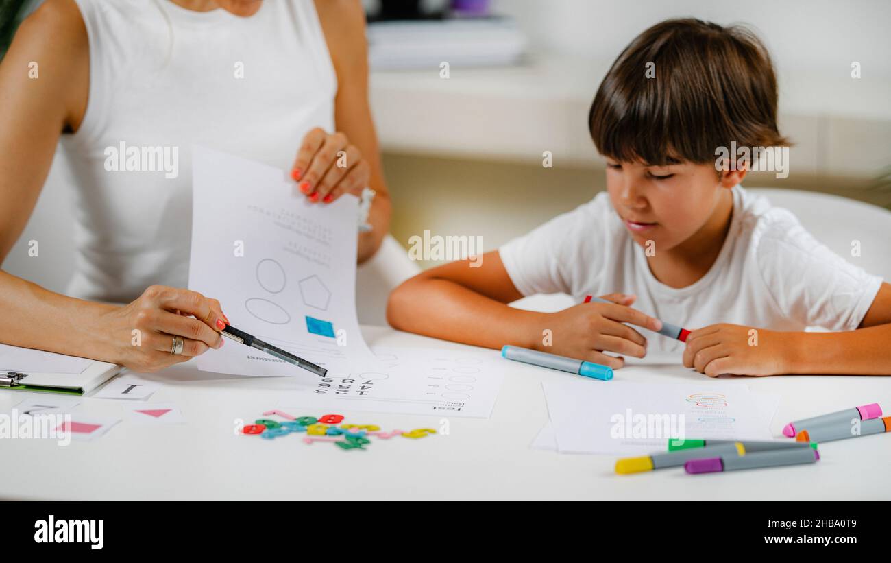 Child colouring shapes in a preschool assessment Stock Photo - Alamy