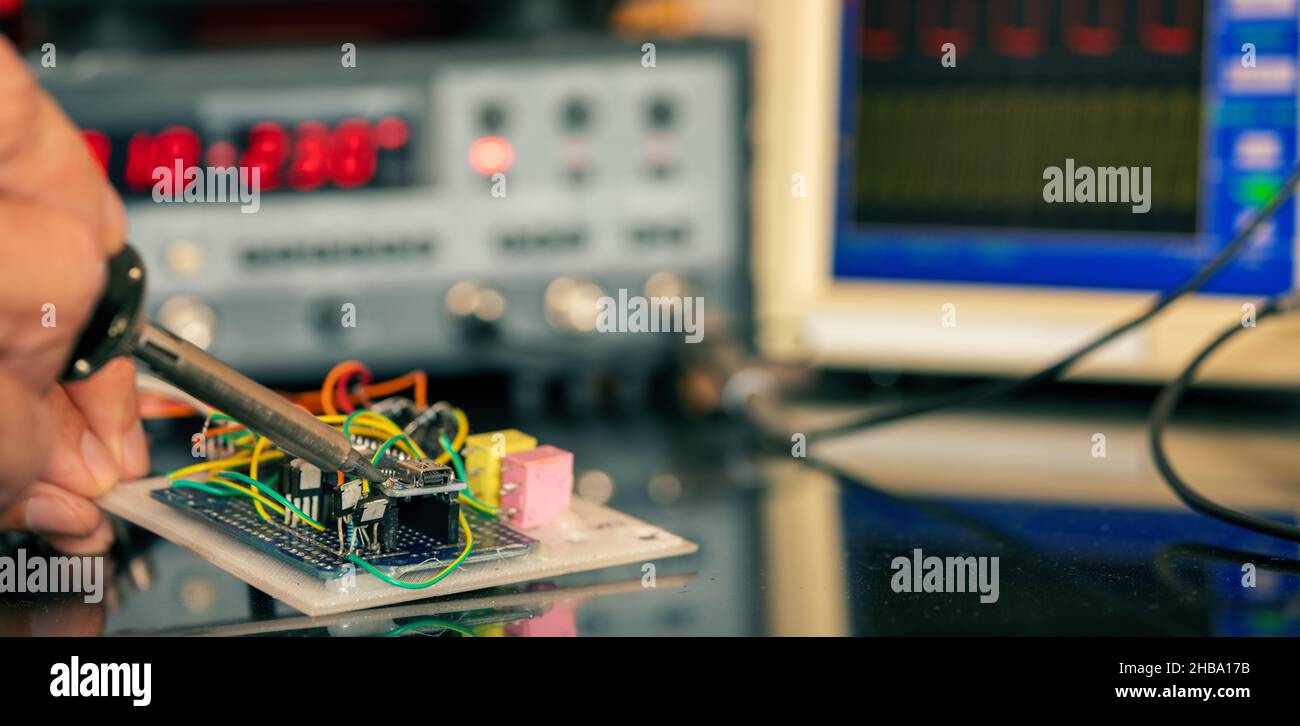 Soldering an electronic device Stock Photo - Alamy