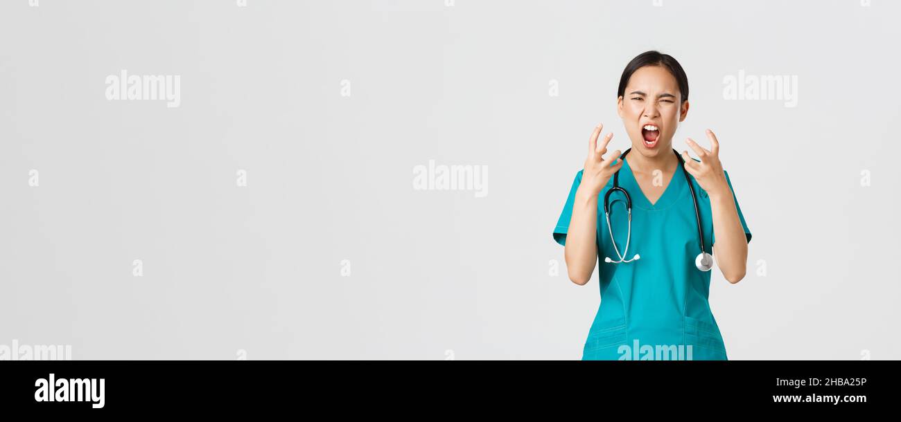 Covid-19, healthcare workers and preventing virus concept. Angry pissed ...