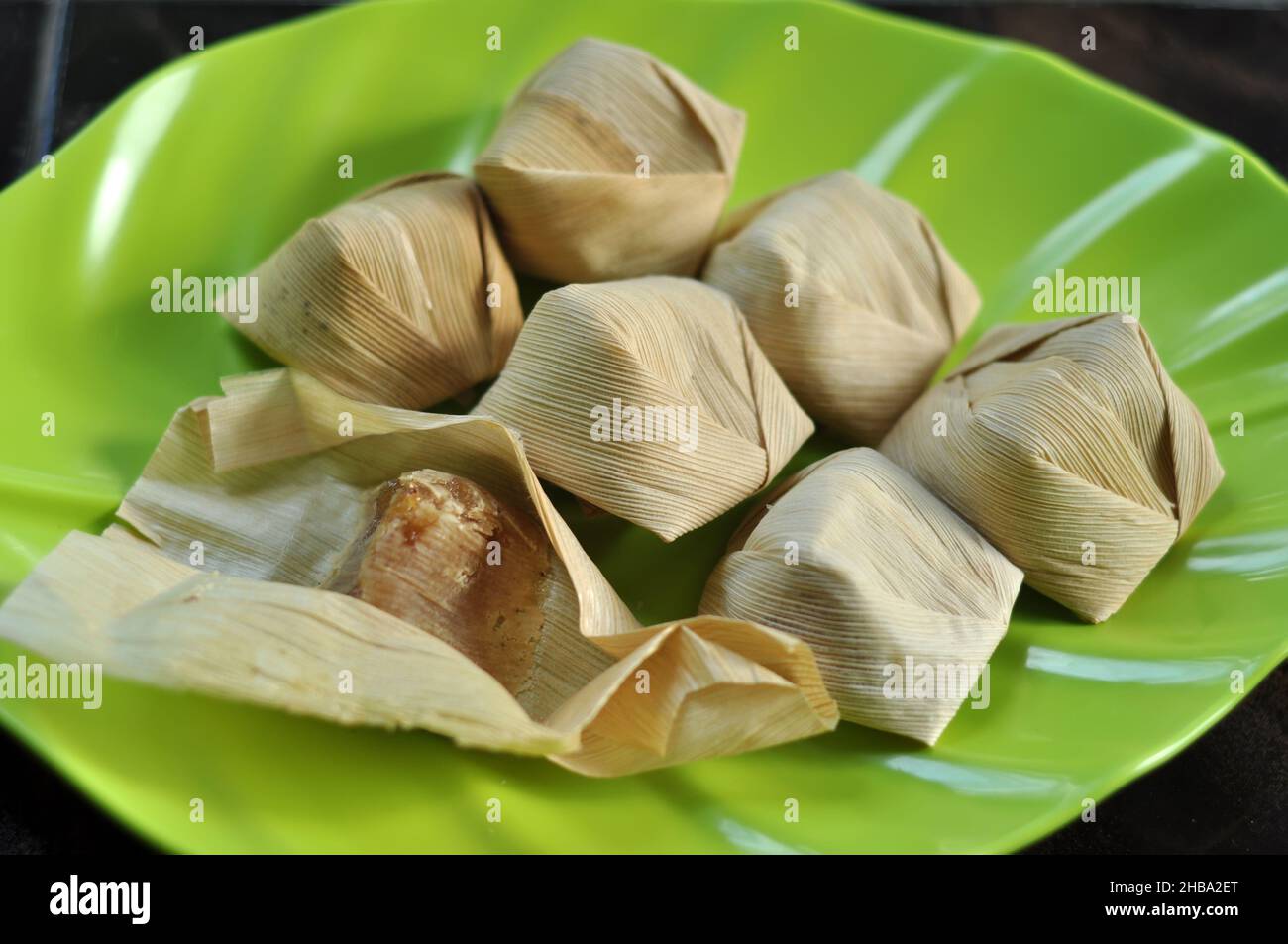 Close-up of the Indonesian traditional food wajit on green plate. Wajit ...